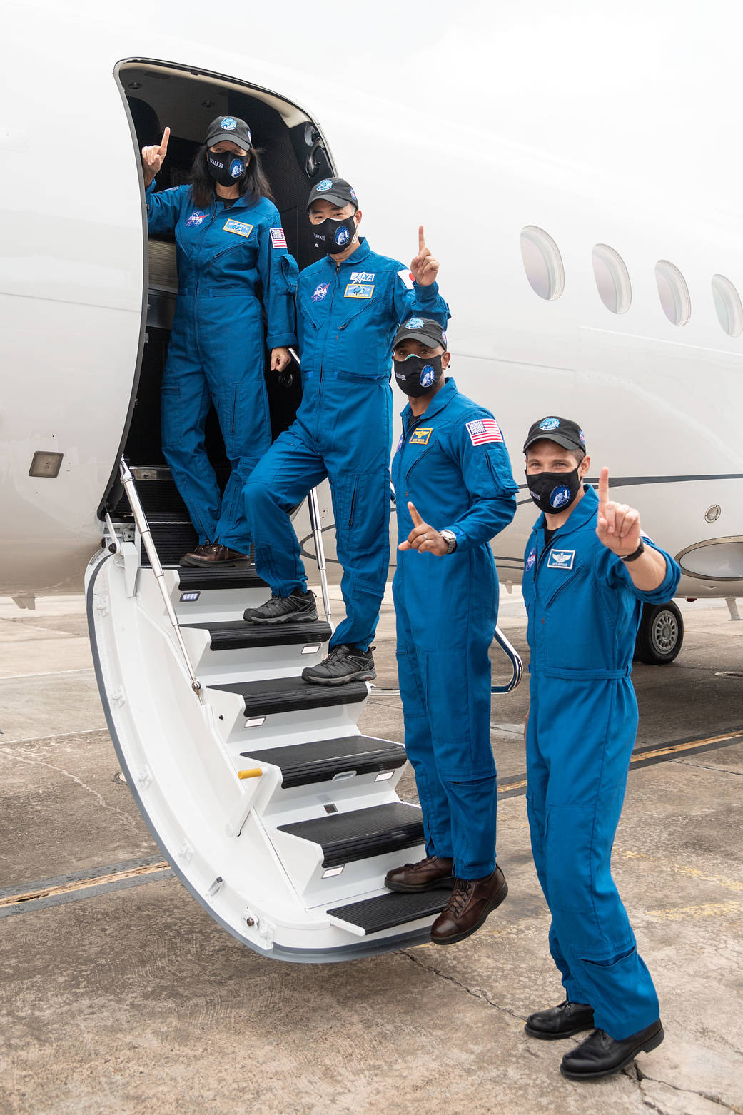 SpaceX Crew-1 crewmates board their jet at Ellington Field in Houston ...